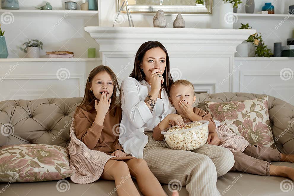 Mamma Sitter På Soffan Med Sin Son Och Dotter Och Tittar På En Film En