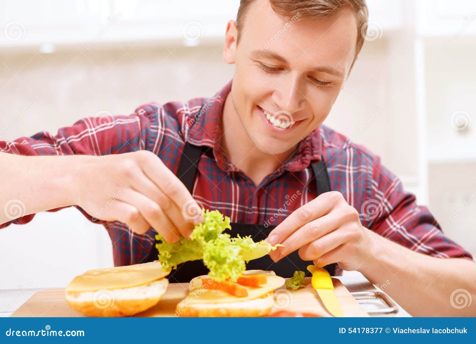 Man Adding Lettuce Leaves To His Sandwich Stock Image - Image of bread ...