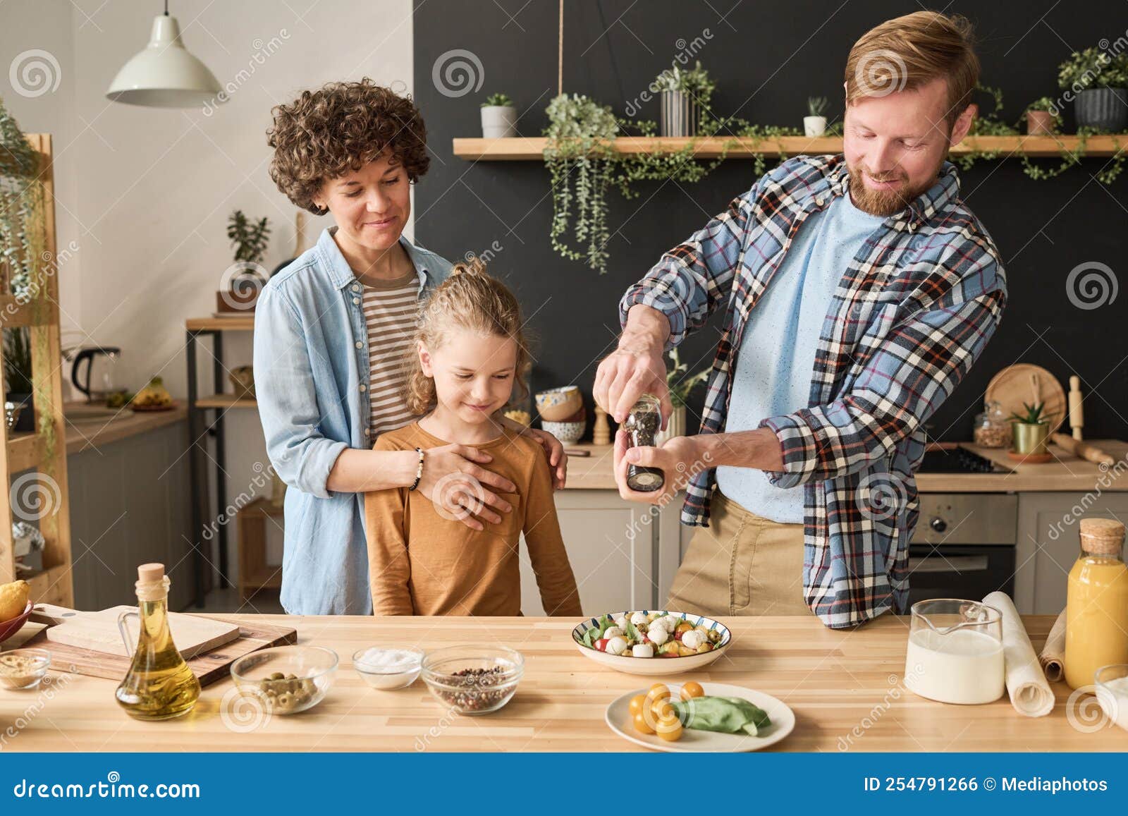 Man adding pepper in salad stock photo. Image of together - 254791266