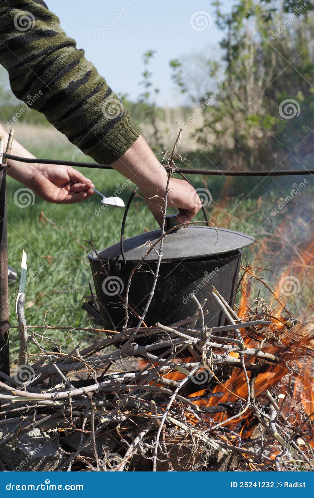 Man adding salt into soup stock photo. Image of boiling - 25241232