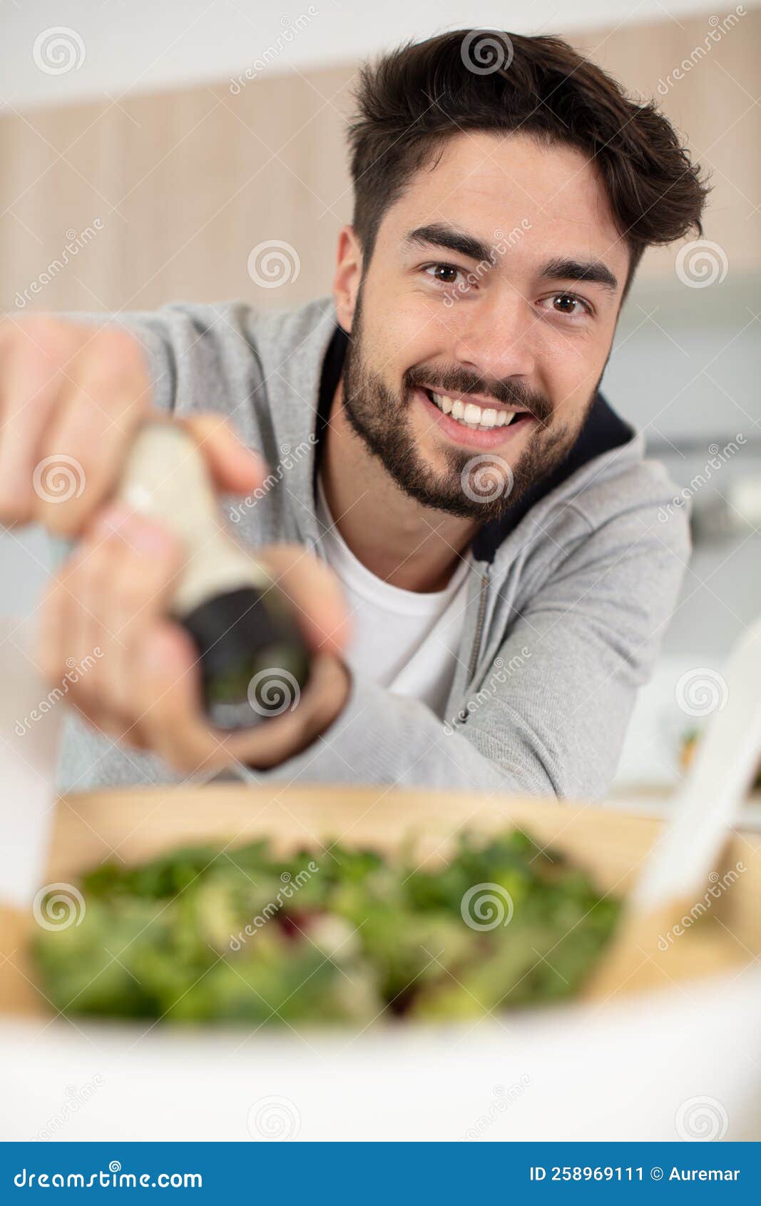 Man Adding Salt To Lunch Salad Stock Image - Image of office, handsome ...