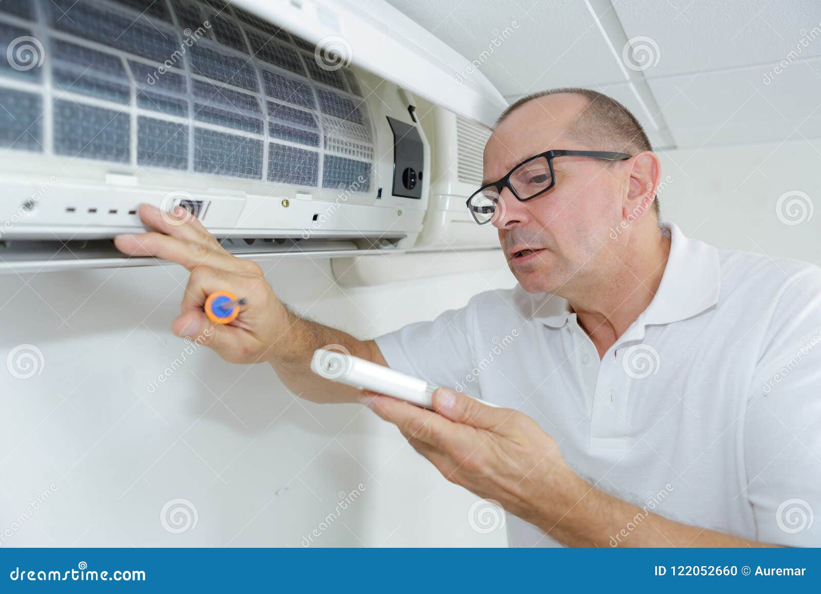 Man Adjusting Air Conditioning System Stock Photo - Image of person ...