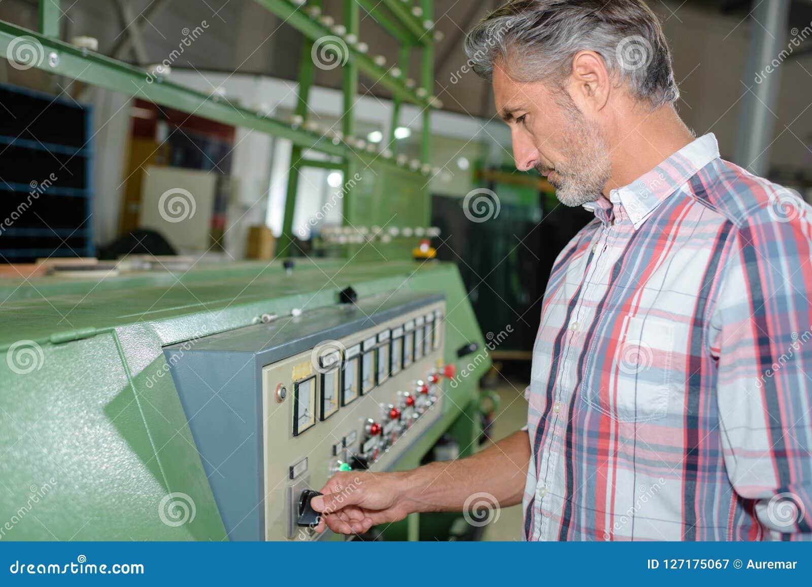 Man Adjusting Controls on Machine in Factory Stock Image - Image of ...