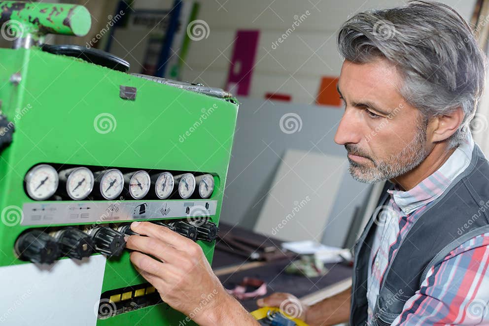 Man Adjusting Dial on Control Panel Stock Image - Image of equipment ...