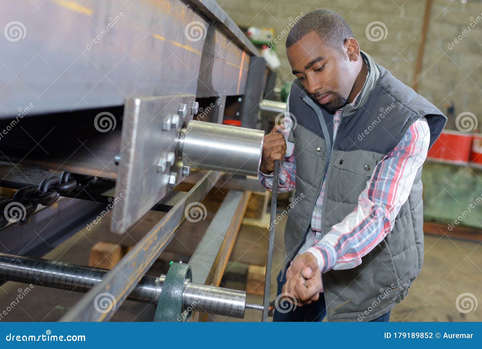 Man adjusting machinery stock photo. Image of vocation - 179189852
