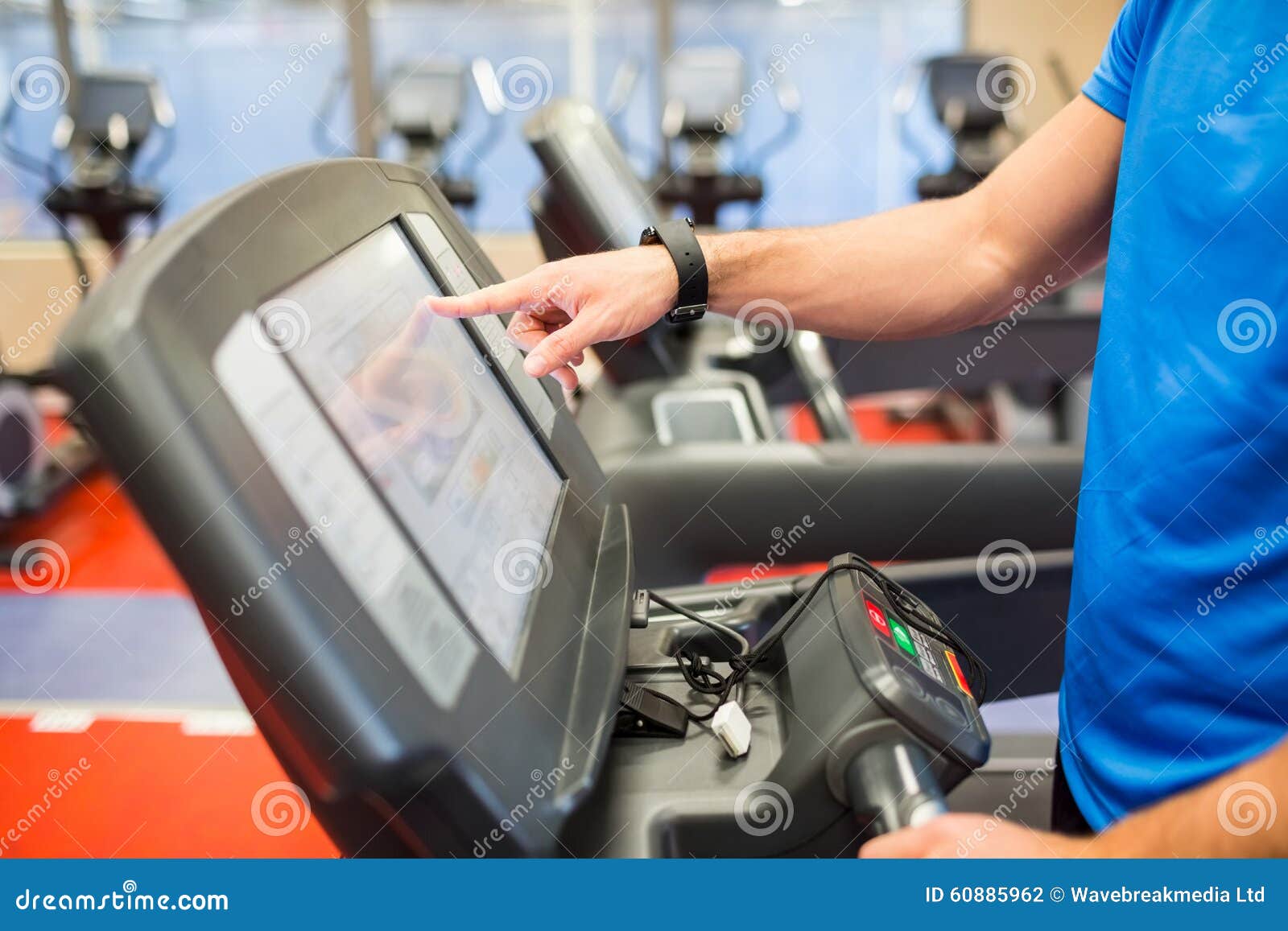 Man Adjusting the Settings of a Treadmill Stock Photo - Image of ...