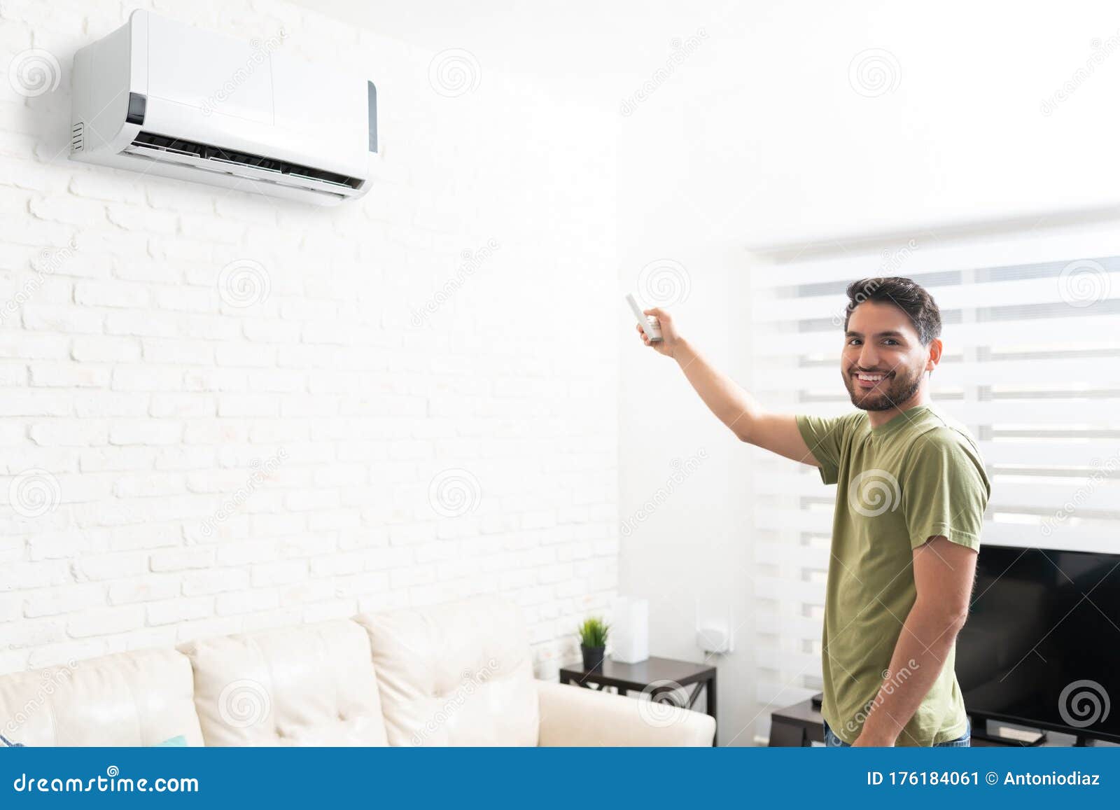 Man Adjusting Temperature of Air Conditioner at Home Stock Image ...