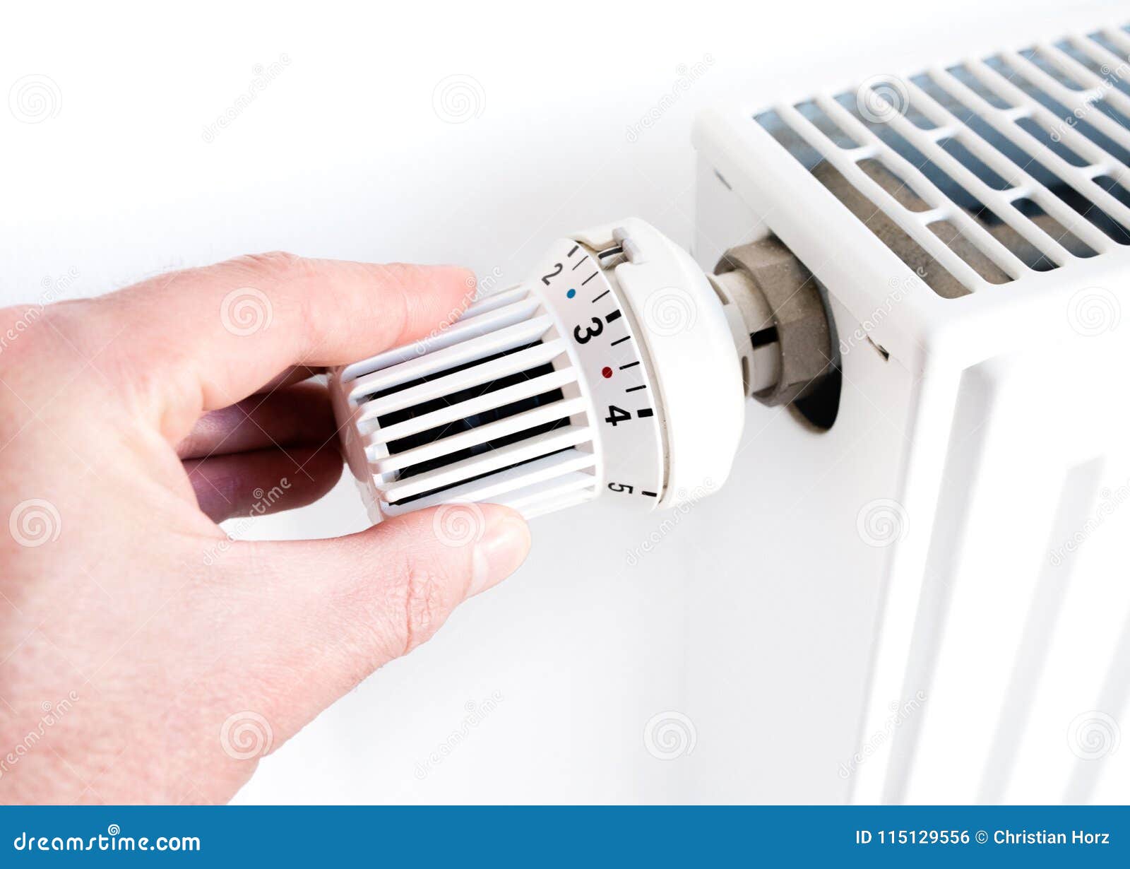 Man Adjusting Temperature on Thermostat on Radiator Stock Photo - Image ...