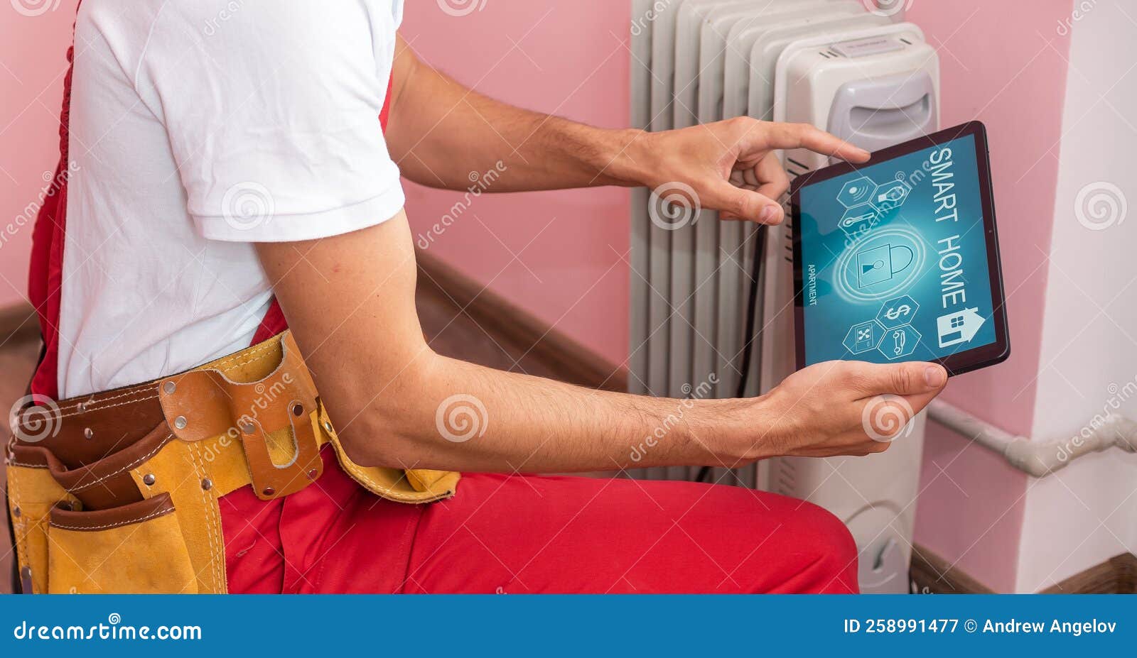 Man is Adjusting a Temperature on the Thermostat Using a Tablet with ...