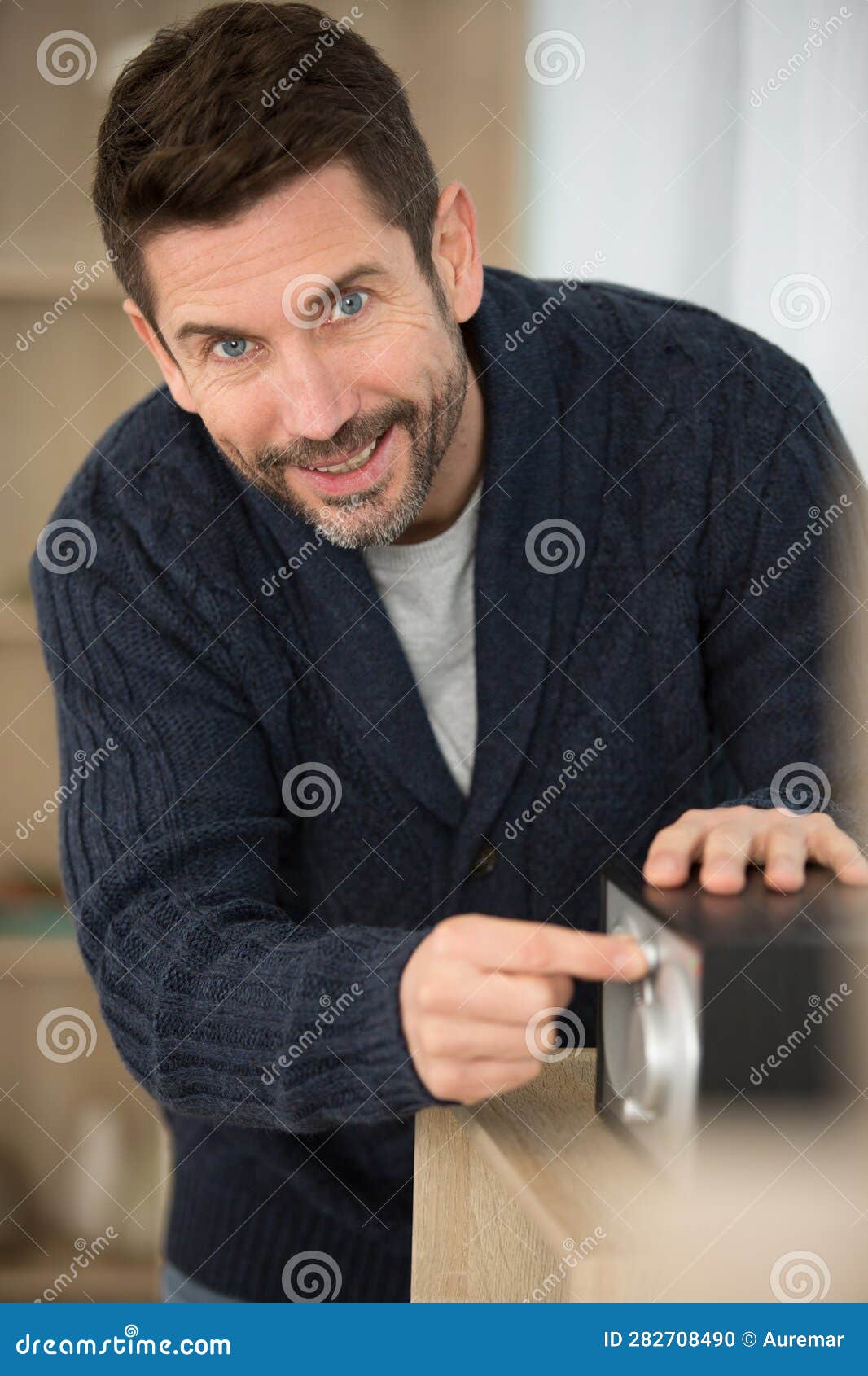 Man Adjusting Volume on Compact Home Stereo Stock Photo - Image of ...