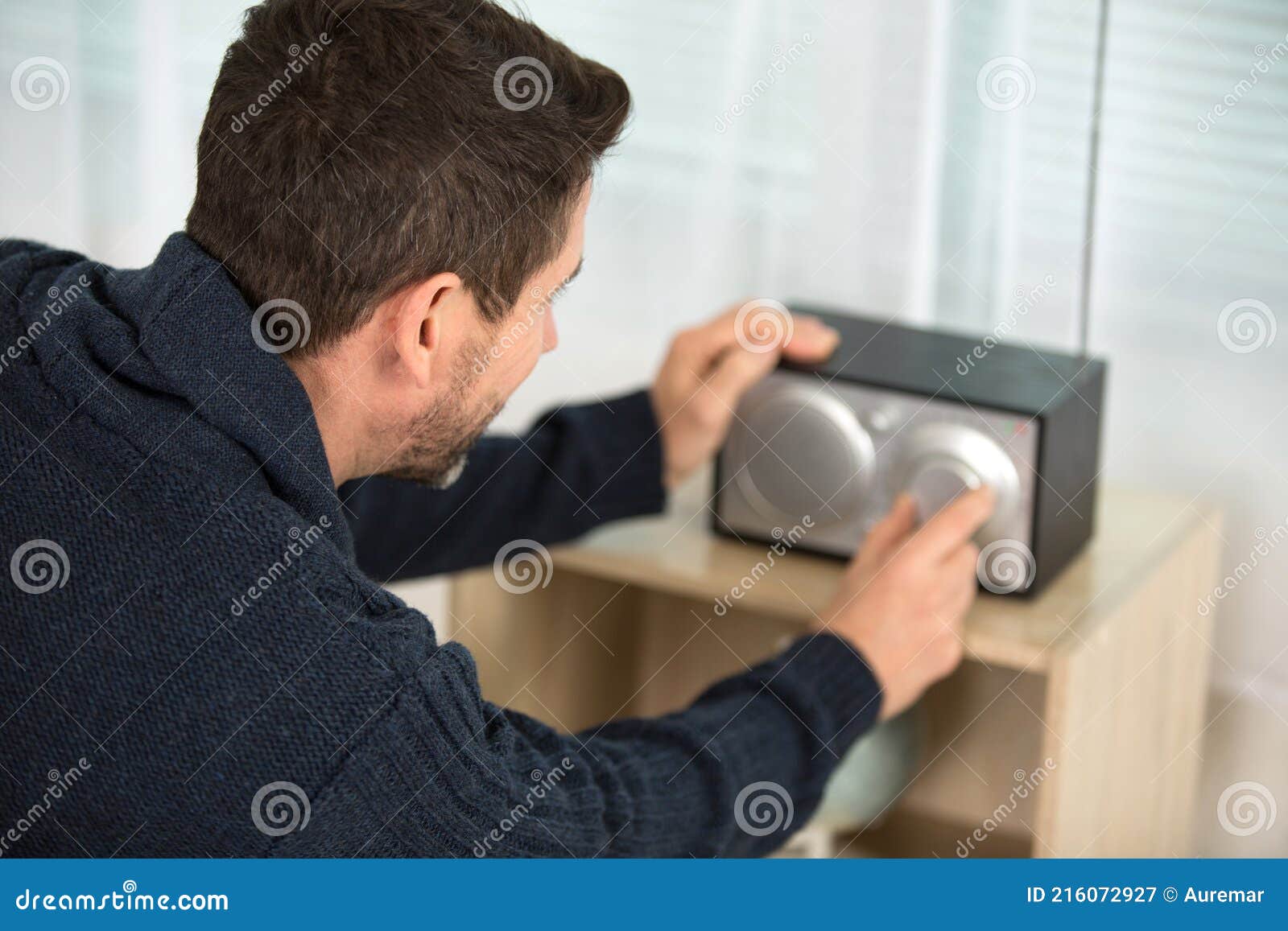Man Adjusting Volume on Wireless Speaker at Home Stock Image - Image of ...