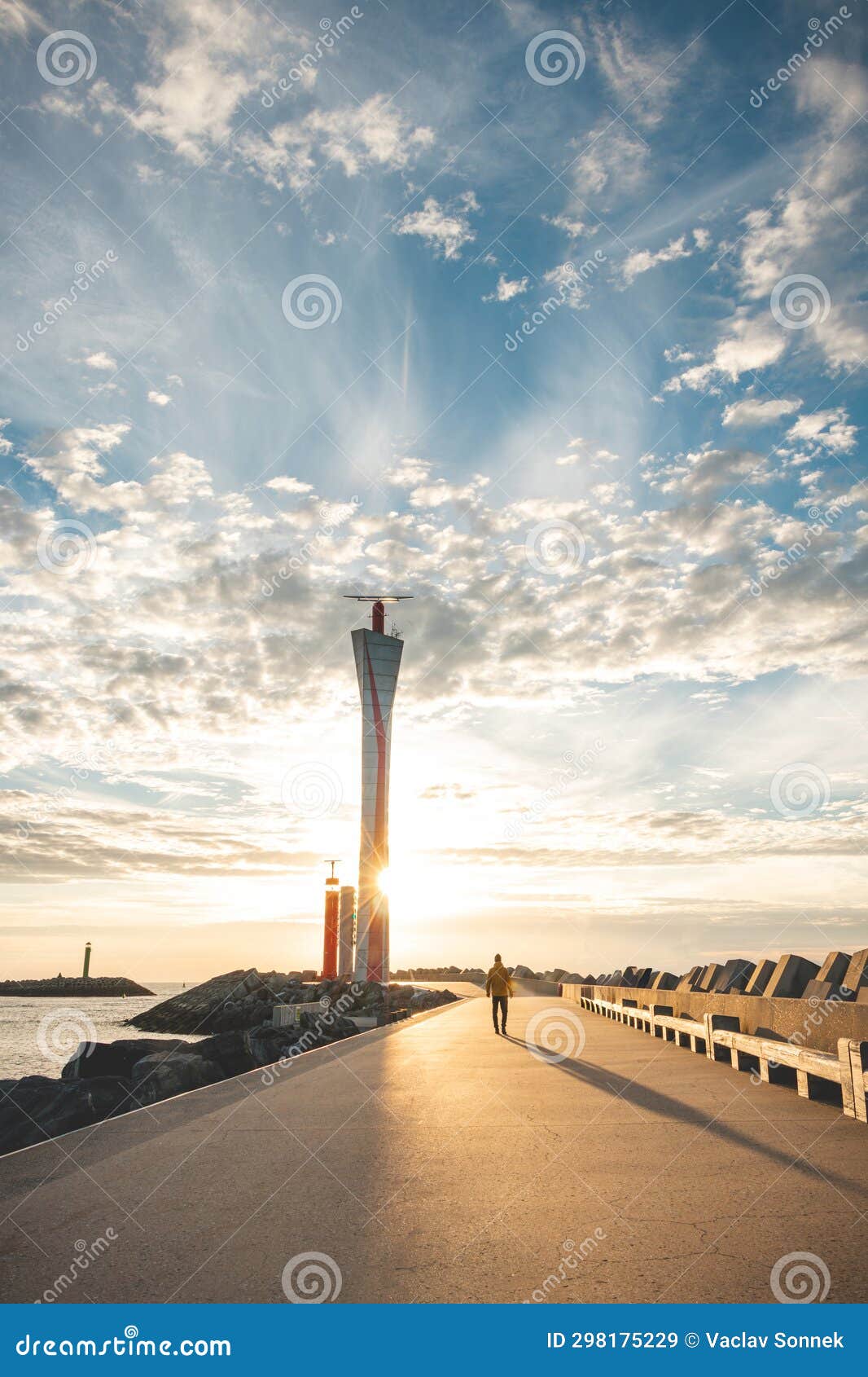 Man Aged 25-29 in a Yellow Jacket Walks Towards a Red-orange Lighthouse ...