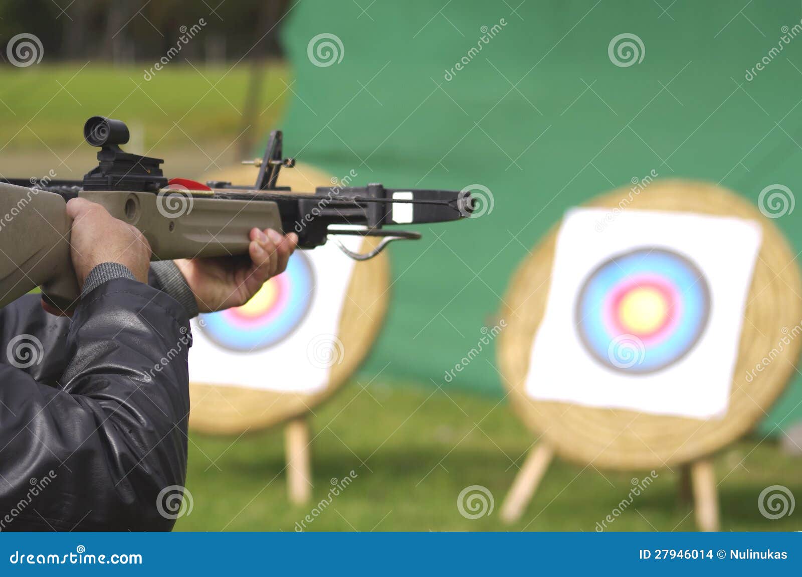 Man Aiming Crossbow at Targets Stock Photo - Image of shooter, hold ...