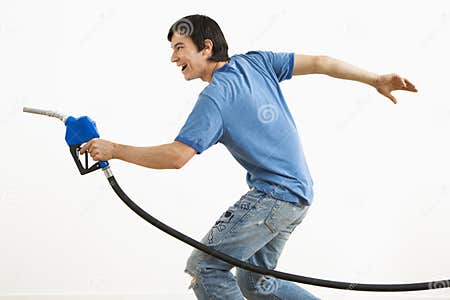 Man aiming gas nozzle. stock photo. Image of fuel, shooting - 6152824