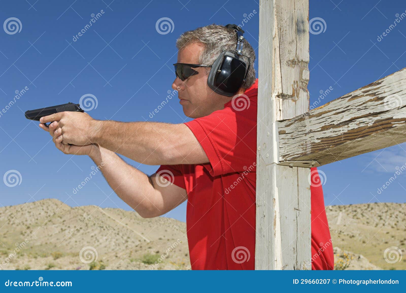Man Aiming Hand Gun at Firing Range Stock Image - Image of profile ...