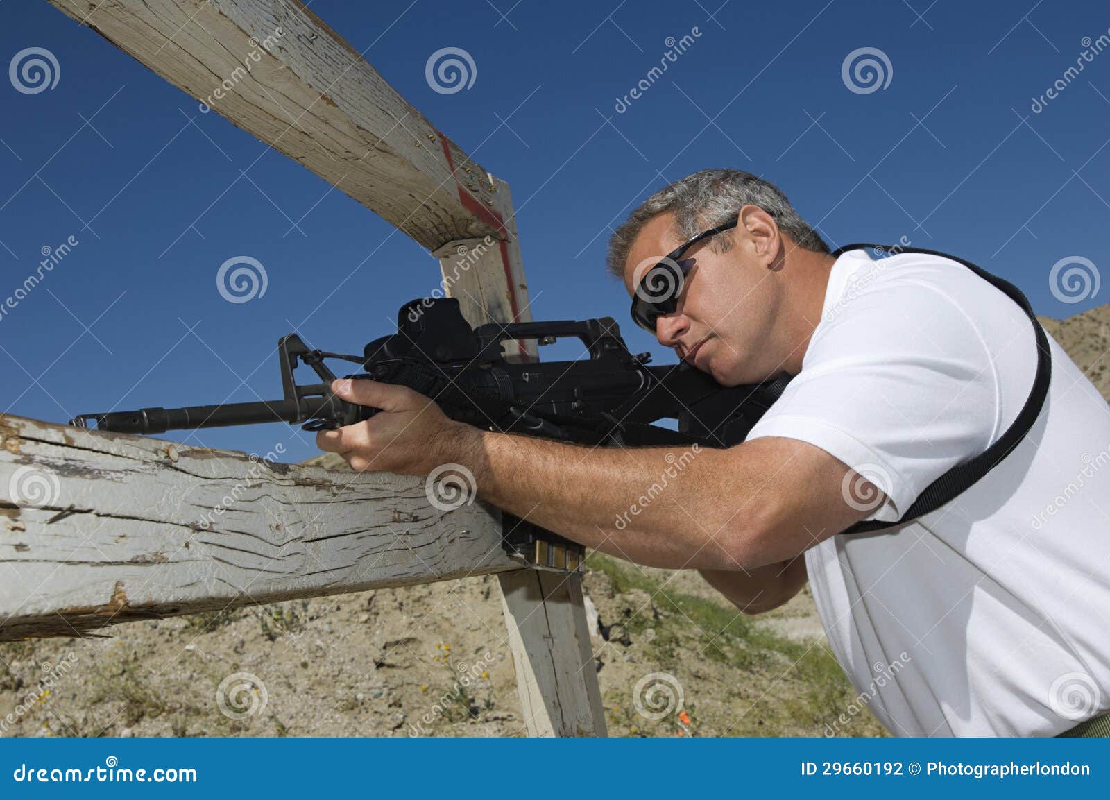 Man Aiming Rifle at Firing Range Stock Photo - Image of male, casual ...