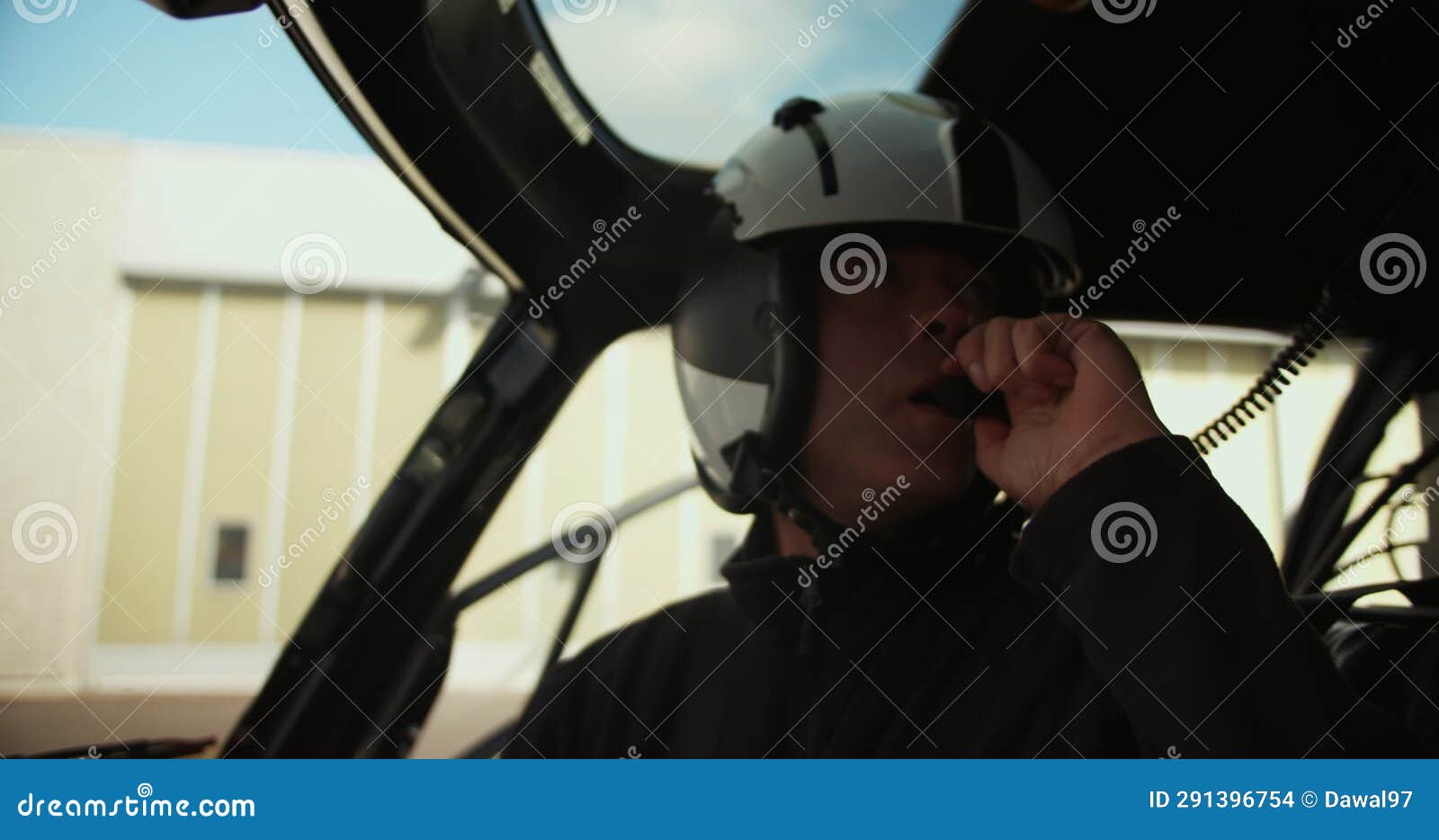 Man in Aircraft Setting Up and Checking Functionality of Microphone ...