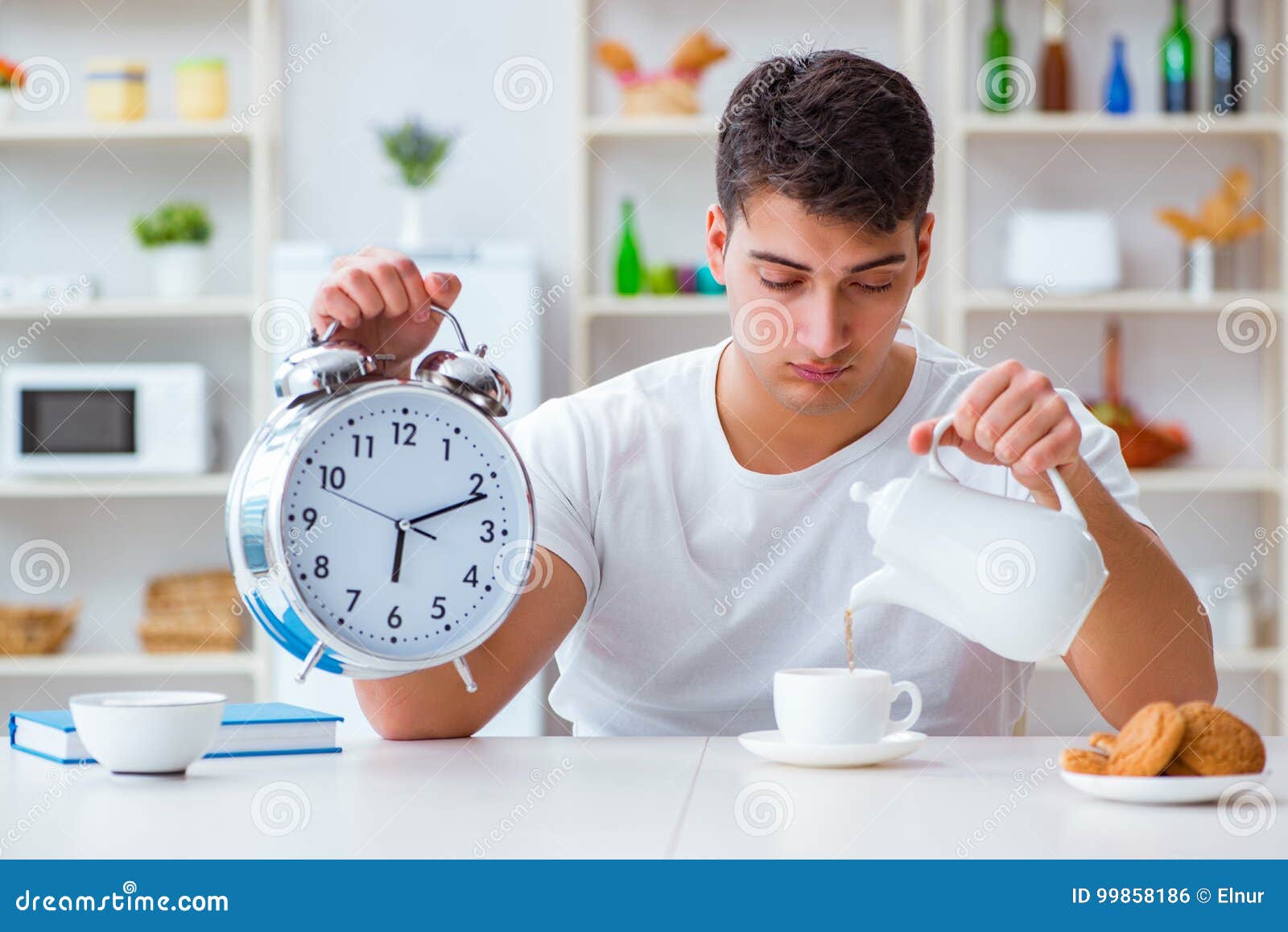 The Man with Alarm Clock Falling Asleep at Breakfast Stock Photo ...