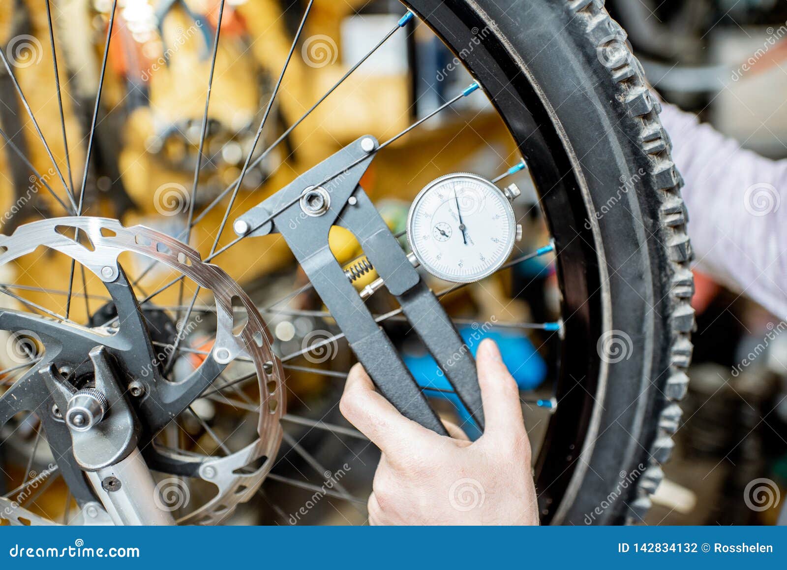 Man Aligning a Bicycle Wheel Stock Photo - Image of service, measuring ...