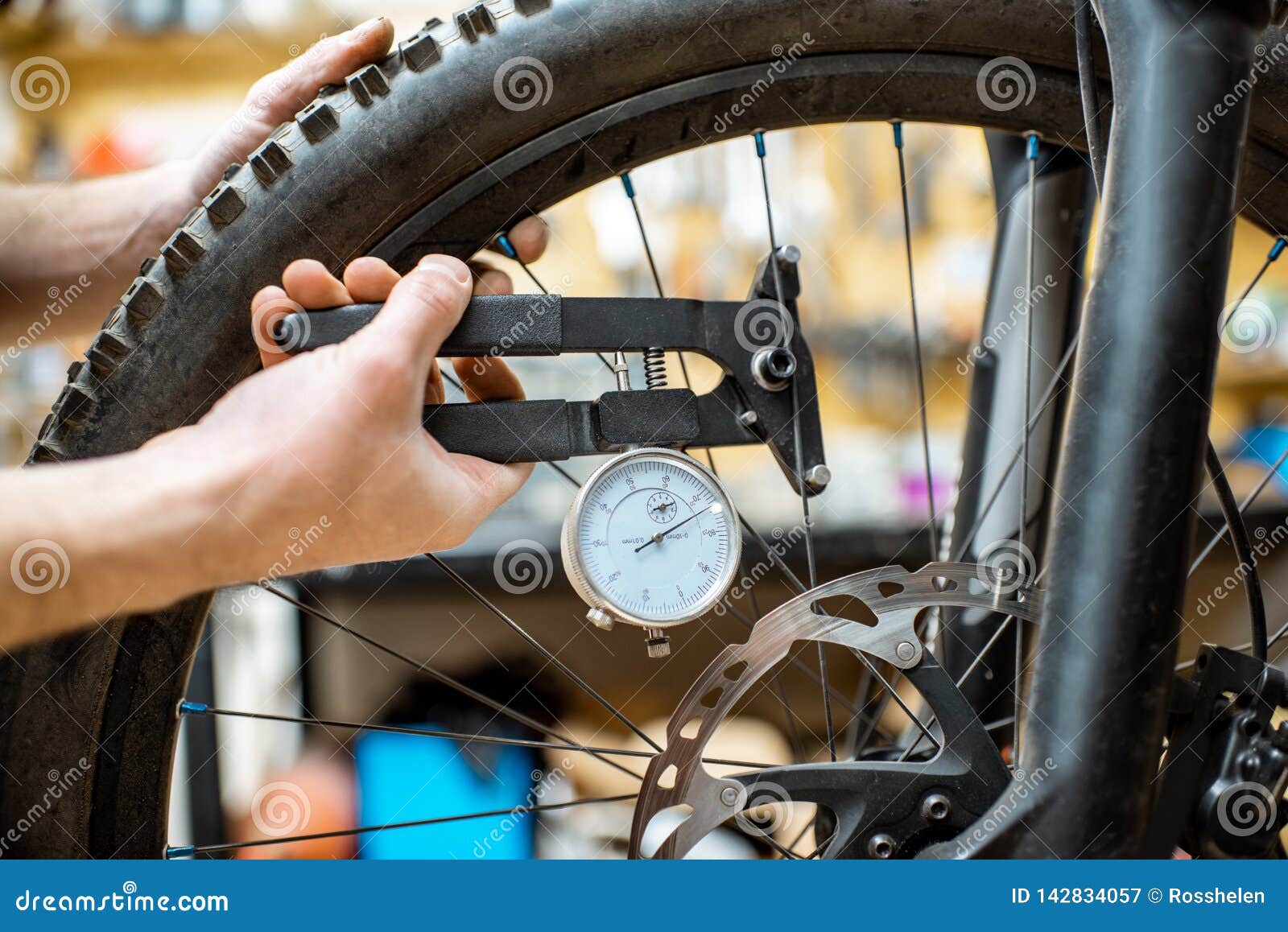 Man Aligning a Bicycle Wheel Stock Image - Image of fixing, male: 142834057