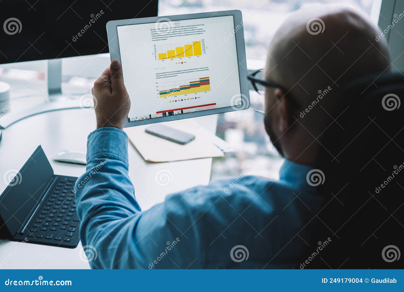 Man Analyzing Charts on Tablet in Office Stock Photo - Image of economy ...