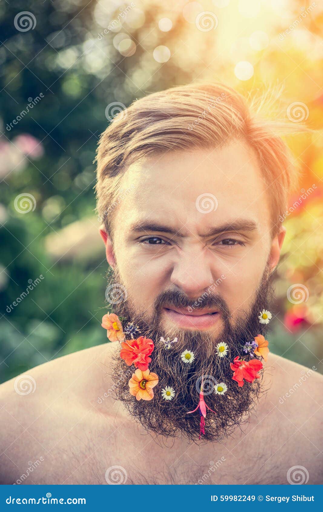 A Man with an Angry Face with a Beard with Flowers His Beard on Natural ...