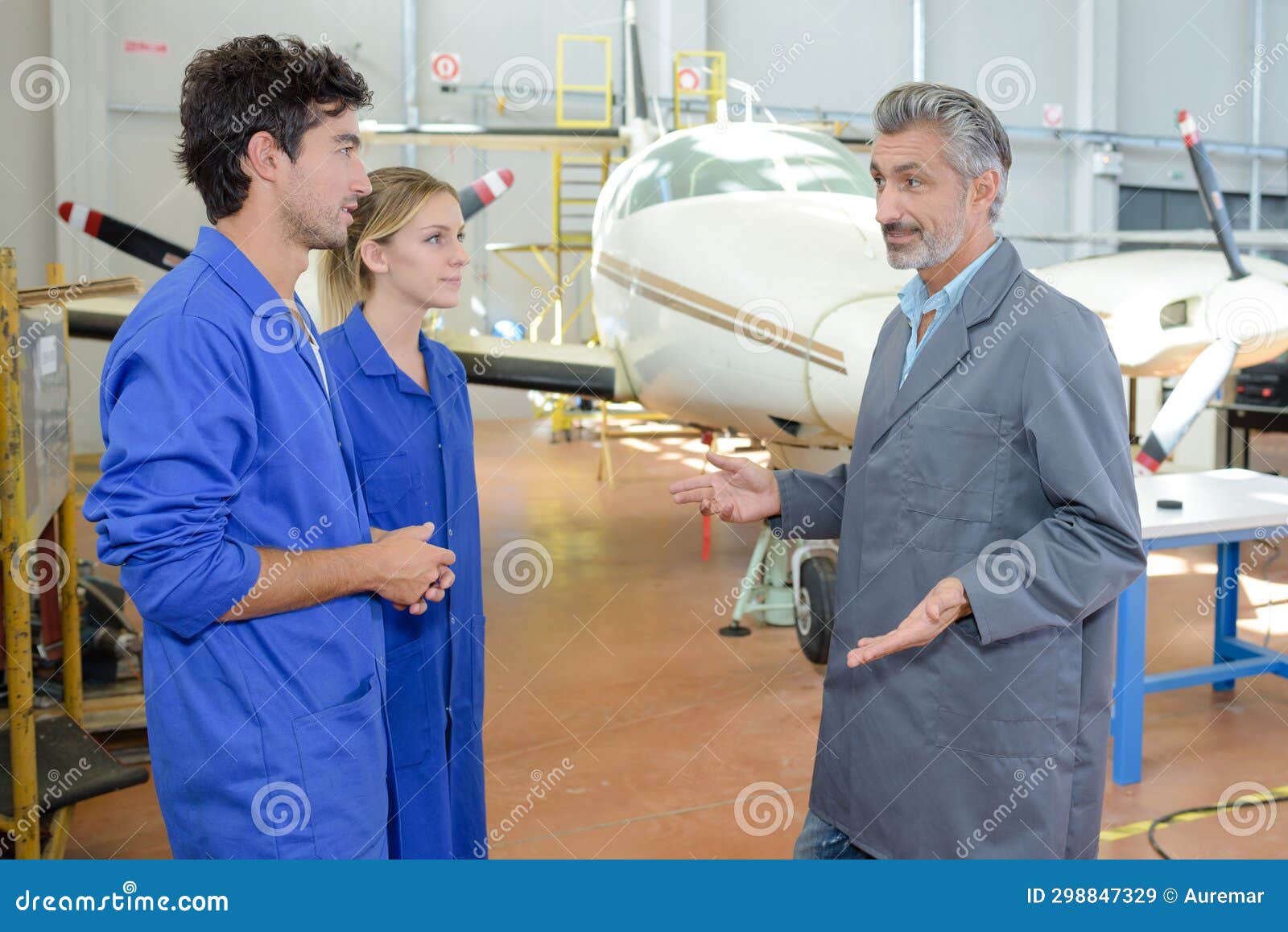 Man Answering Students Questions in Aircraft Hangar Stock Image - Image ...