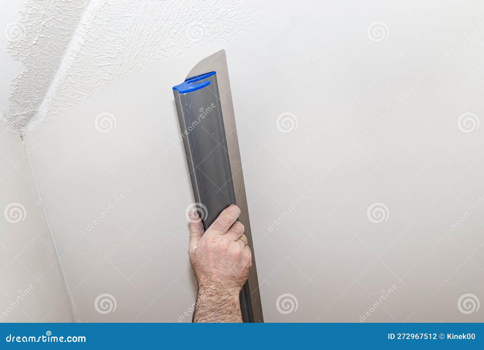 A Man Applies Ready-made Polymer Plaster from a Bucket Using Special ...