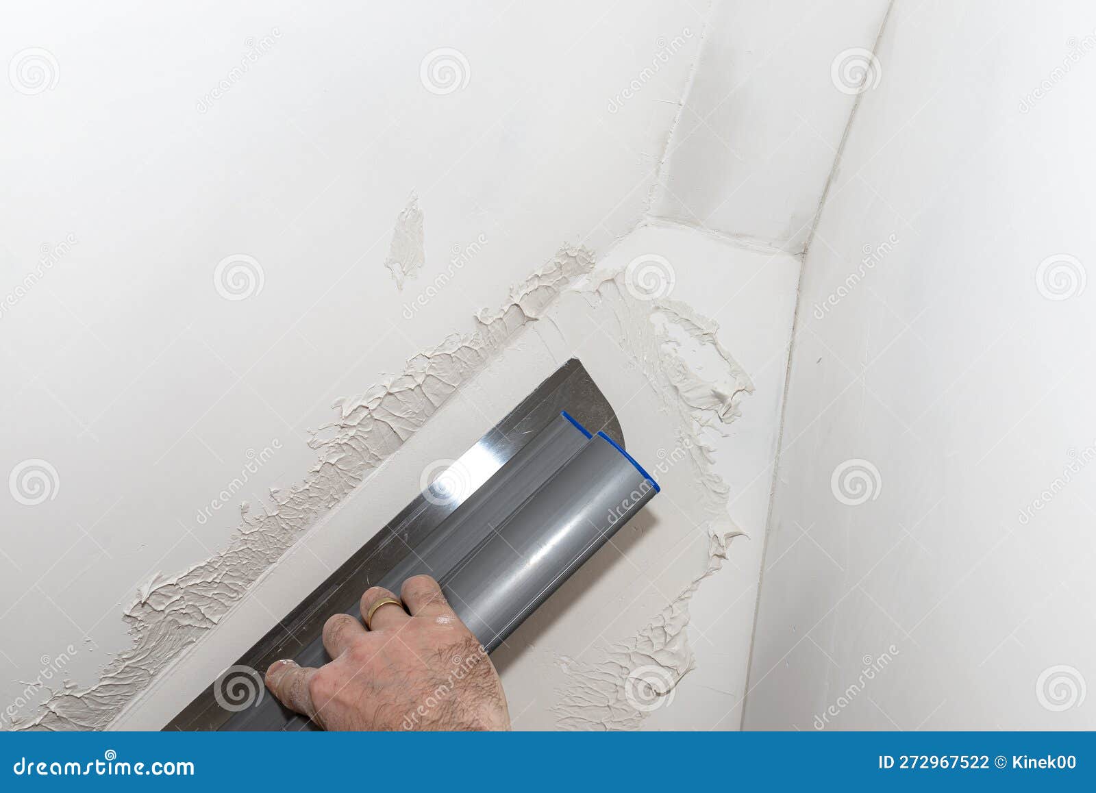 A Man Applies Ready-made Polymer Plaster from a Bucket Using Special ...