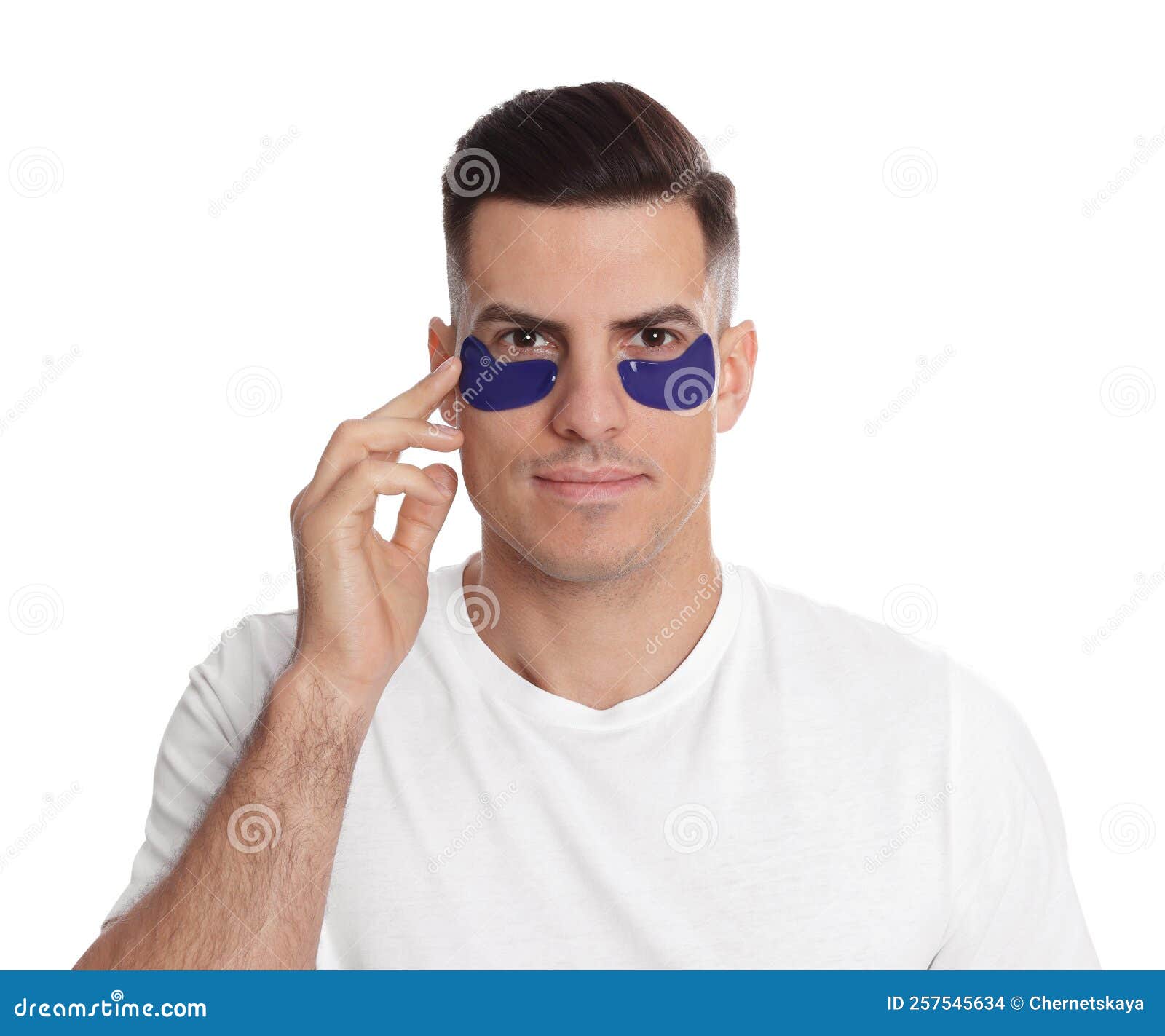 Man Applying Blue Under Eye Patch on White Background Stock Photo ...