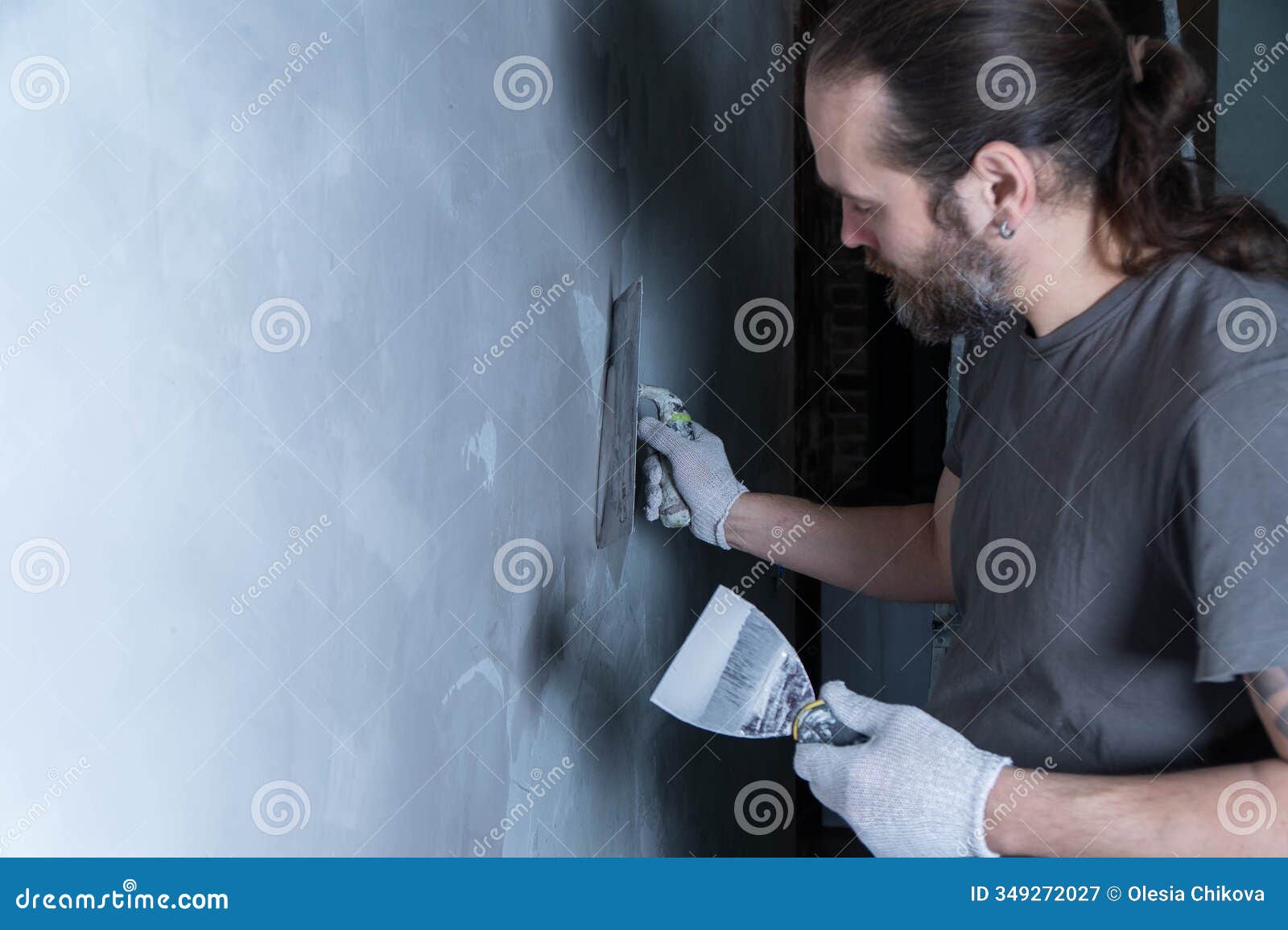 Man Applying Epoxy Adhesive To Wall Surface for Repair Work in Indoor ...