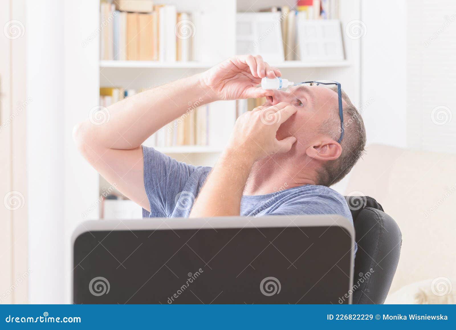 Man applying eye drops stock image. Image of liquid - 226822229