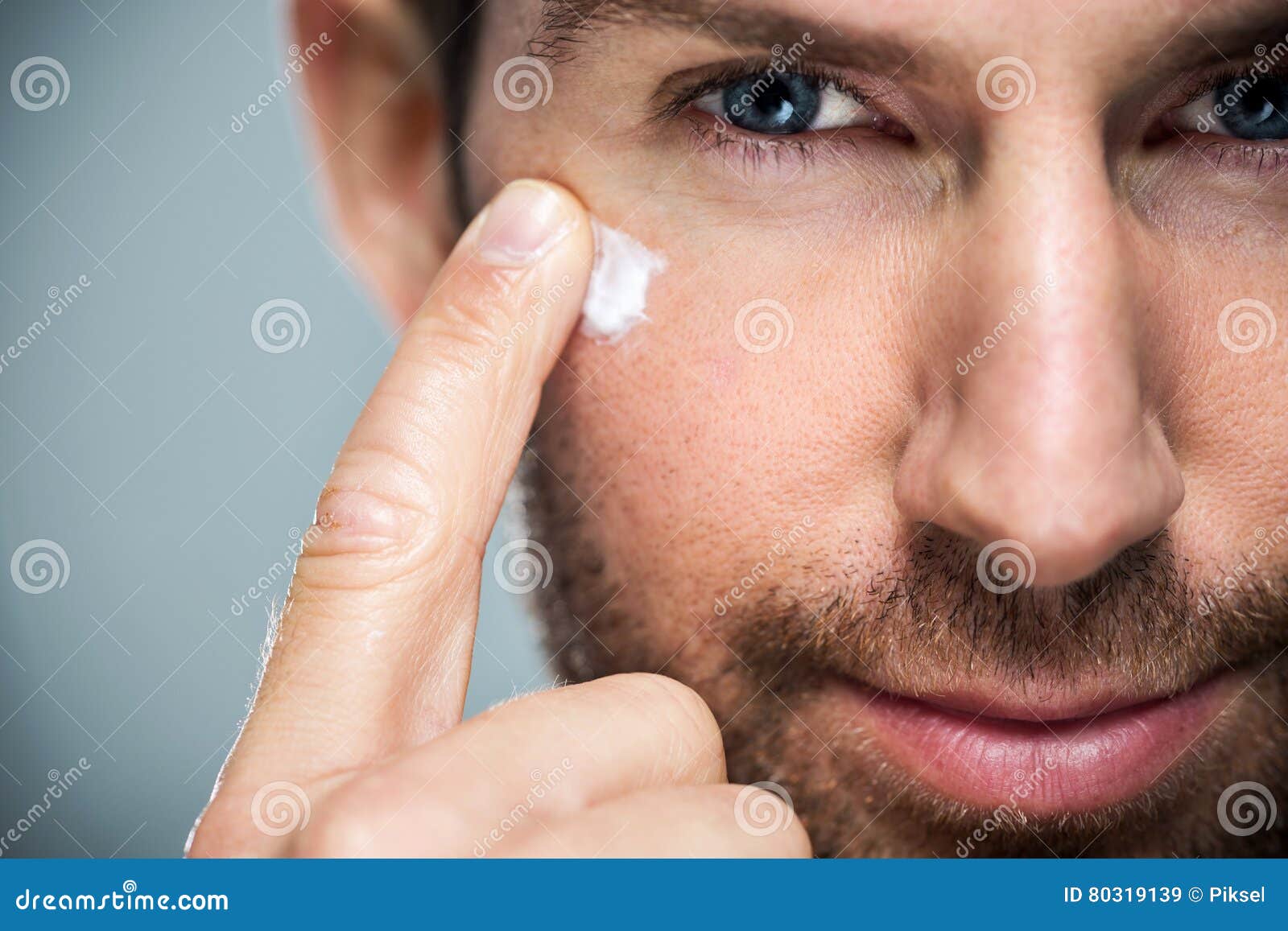 Man applying face cream stock image. Image of confident - 80319139