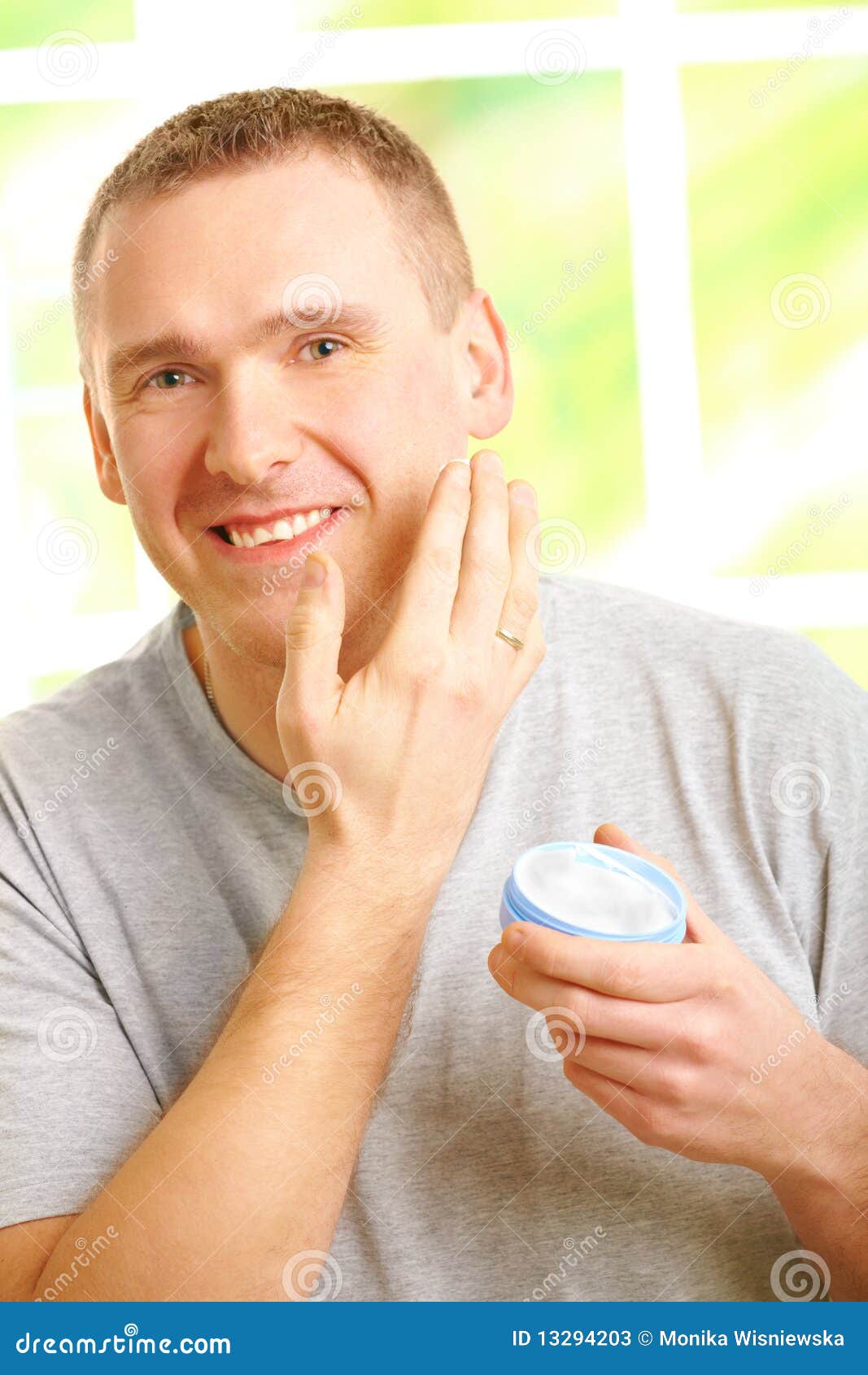 Man applying facial cream stock image. Image of happy - 13294203