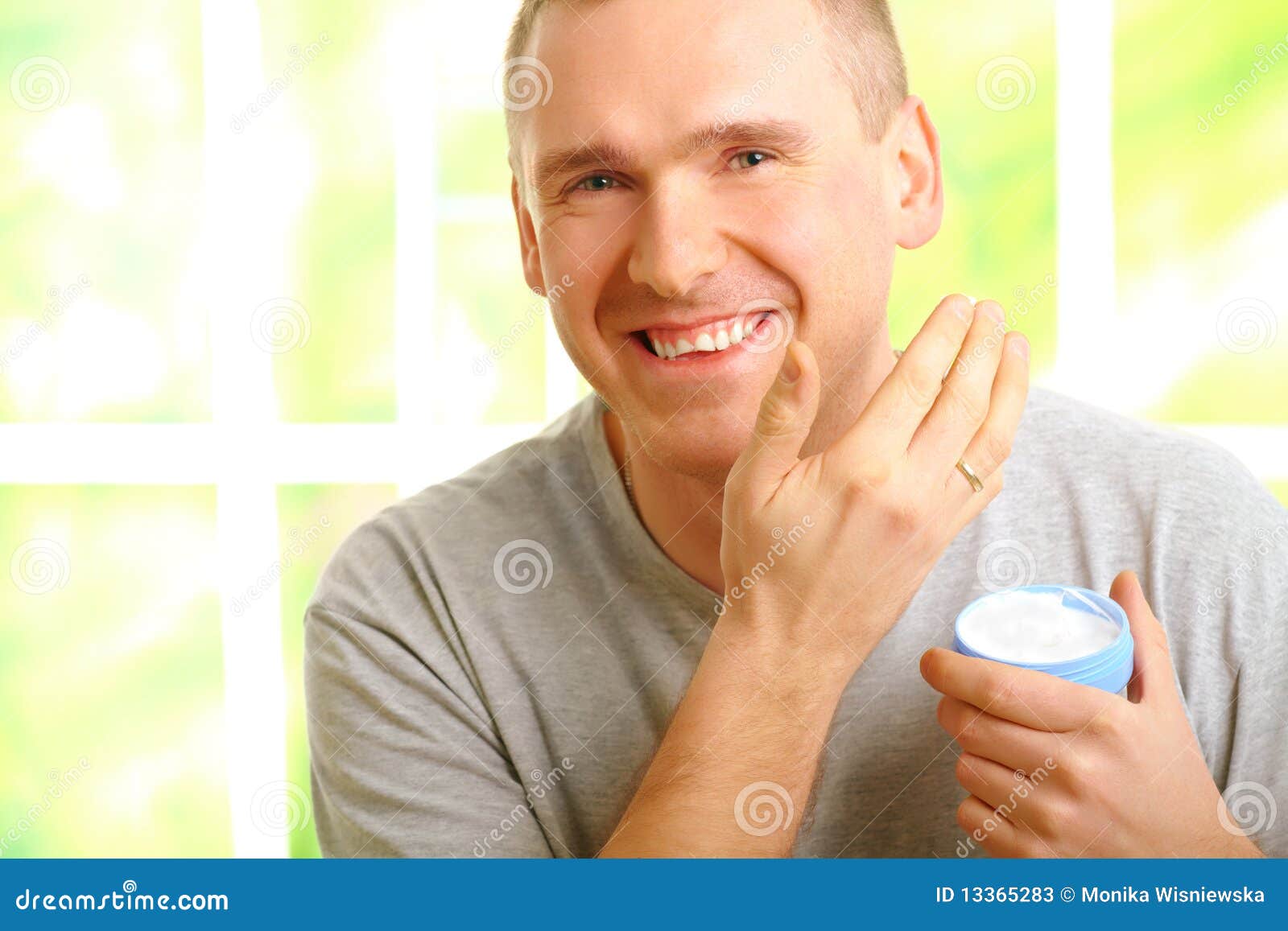 Man applying facial cream stock image. Image of pampered - 13365283