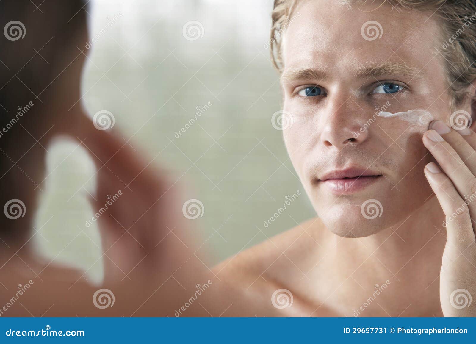 Man Applying Facial Cream stock image. Image of indoors - 29657731