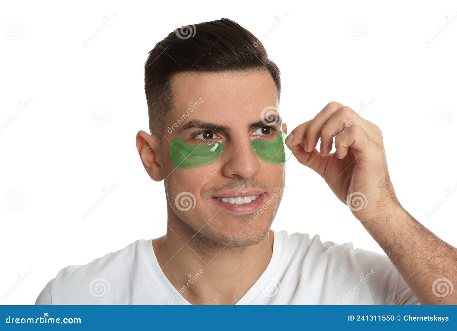 Man Applying Green Under Eye Patch on White Background Stock Photo ...