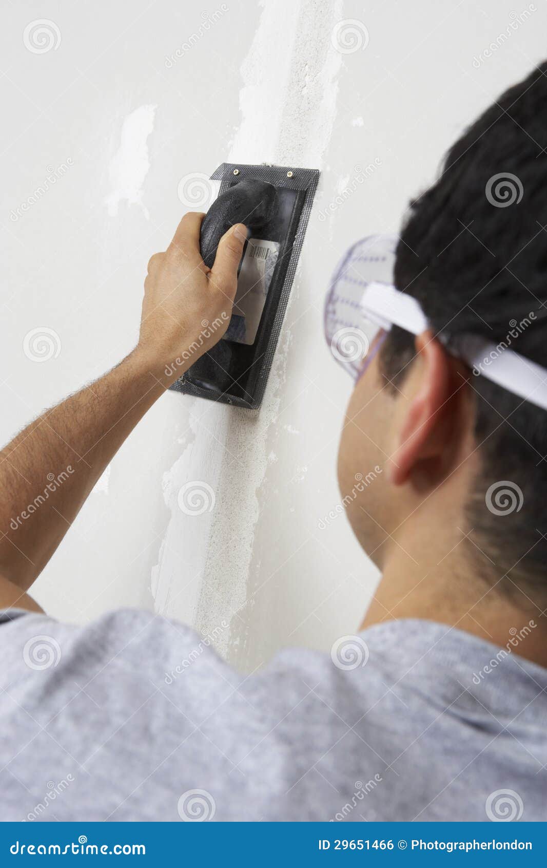 Man Applying Putty on Wall stock photo. Image of indoor - 29651466