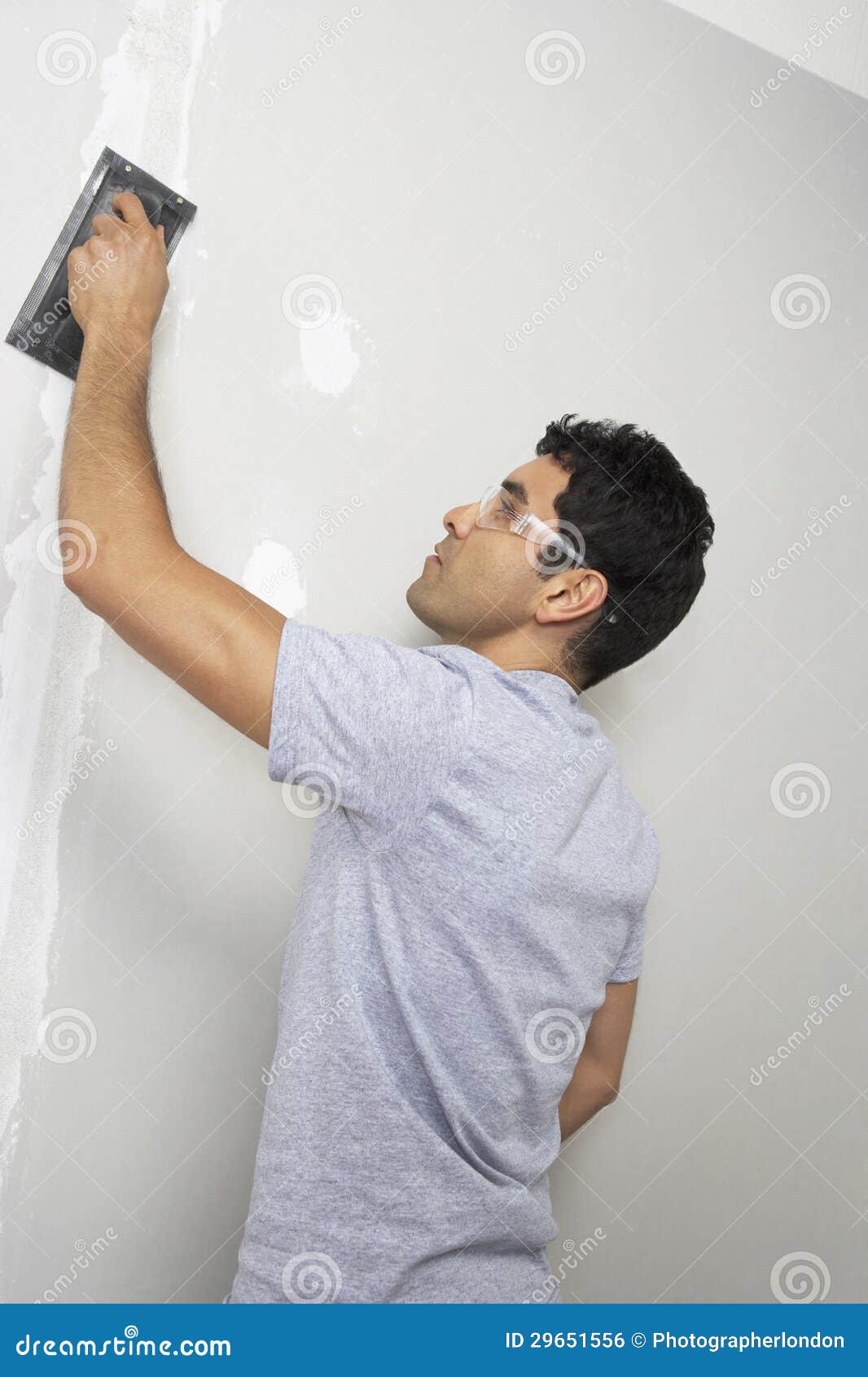 Man Applying Putty on Wall stock photo. Image of filler - 29651556