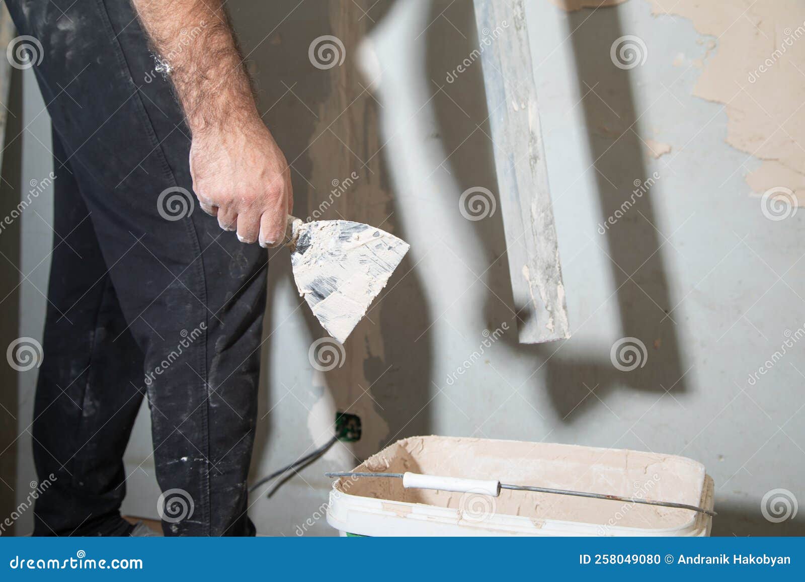 Man is Applying Putty on a Wall. Renovating House Stock Photo - Image ...