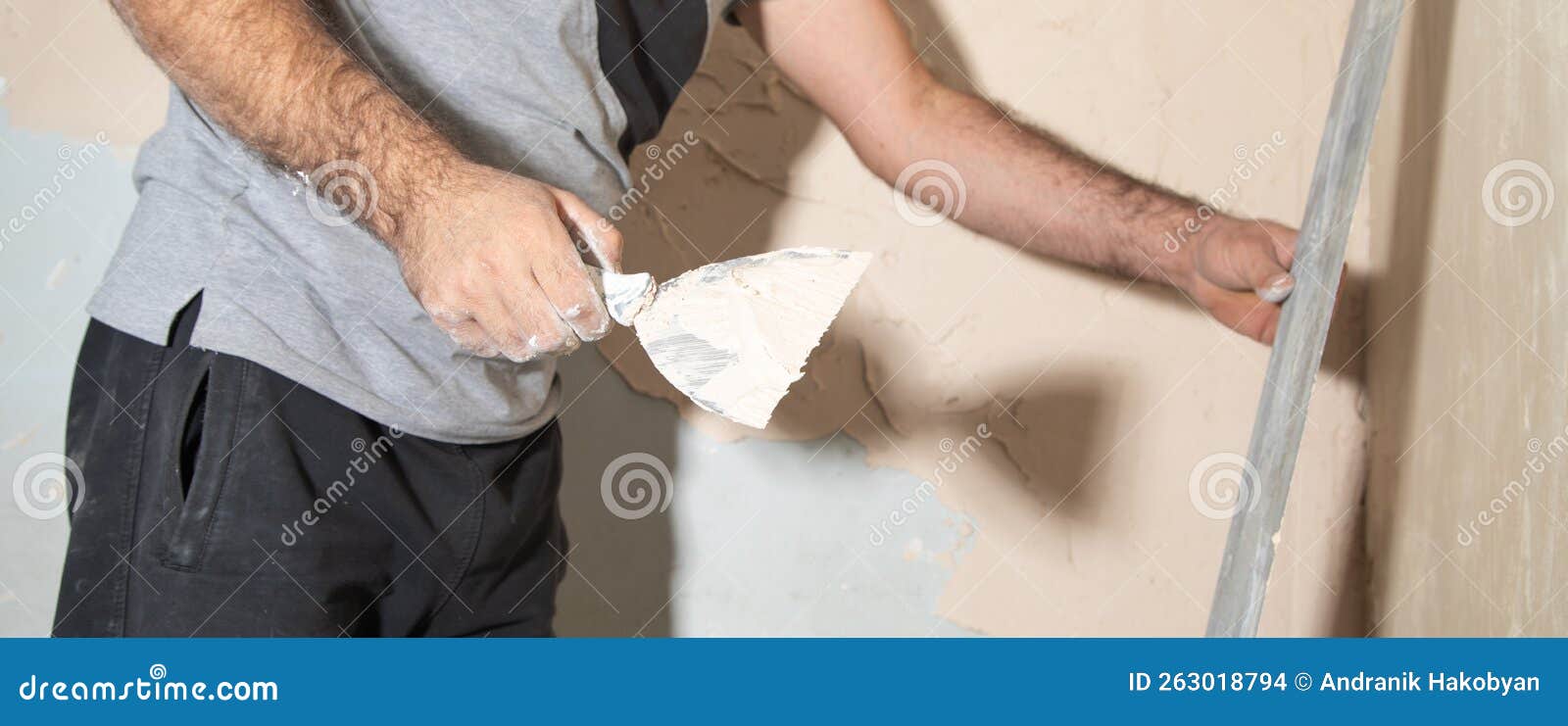 Man is Applying Putty on a Wall. Renovating House Stock Photo - Image ...