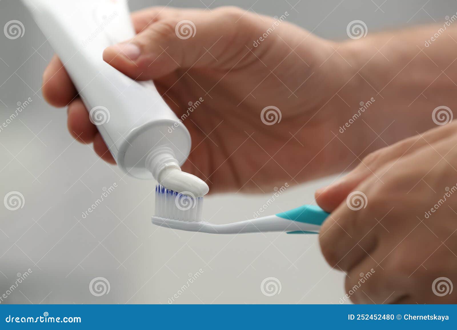 Man Applying Toothpaste on Brush Against Blurred Background, Closeup ...