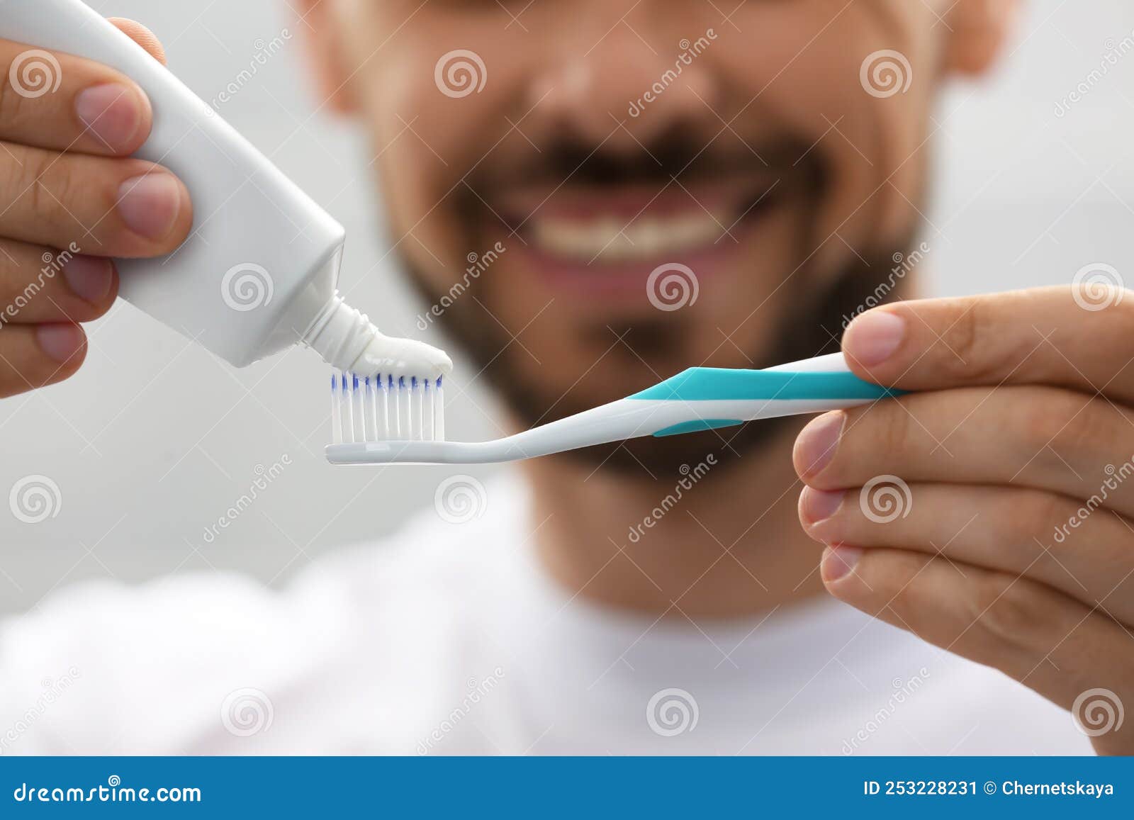 Man Applying Toothpaste on Brush Against Blurred Background, Closeup ...