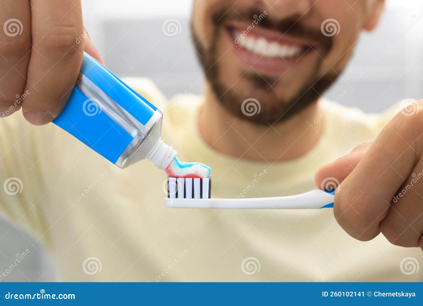 Man Applying Toothpaste on Brush Against Blurred Background, Closeup ...