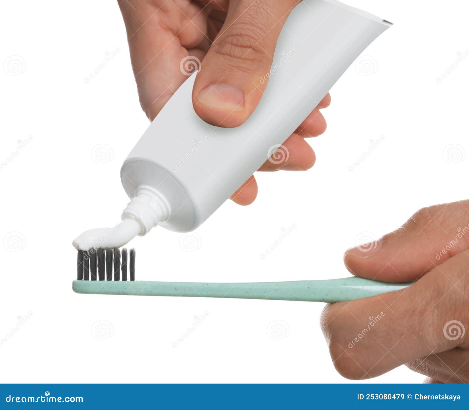 Man Applying Toothpaste on Brush Against White Background, Closeup ...