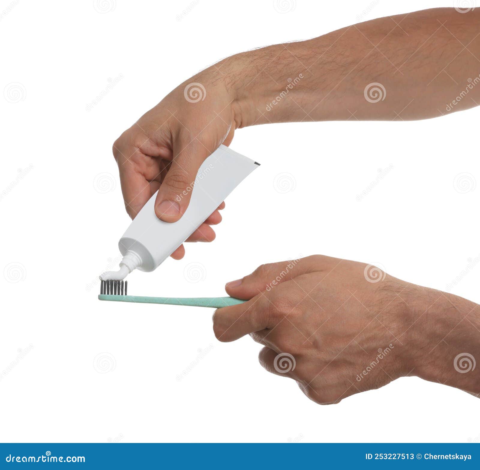 Man Applying Toothpaste on Brush Against White Background, Closeup ...