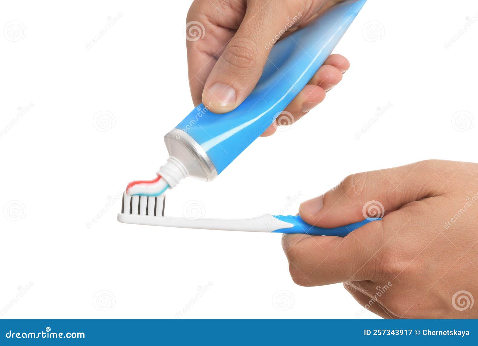 Man Applying Toothpaste on Brush Against White Background, Closeup ...