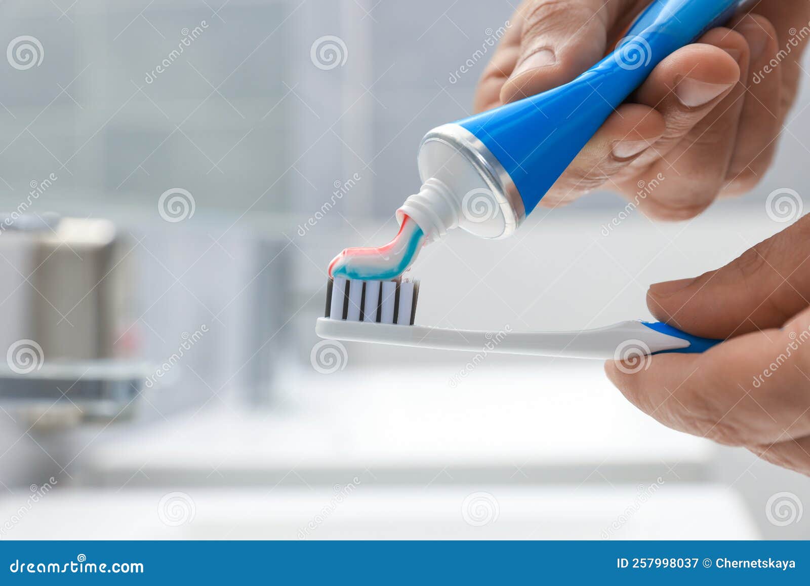 Man Applying Toothpaste on Brush in Bathroom, Closeup. Space for Text ...