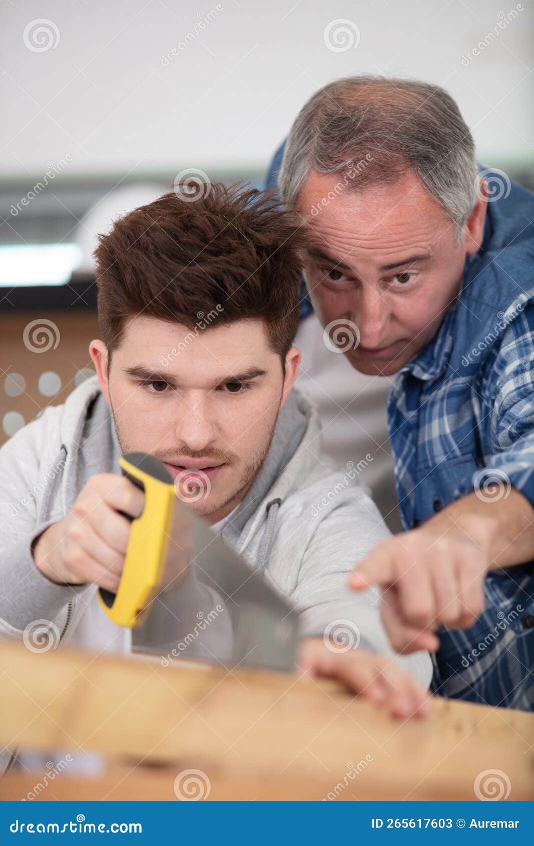 Man and Apprentice Learning To Cut Wood Stock Image - Image of persons ...