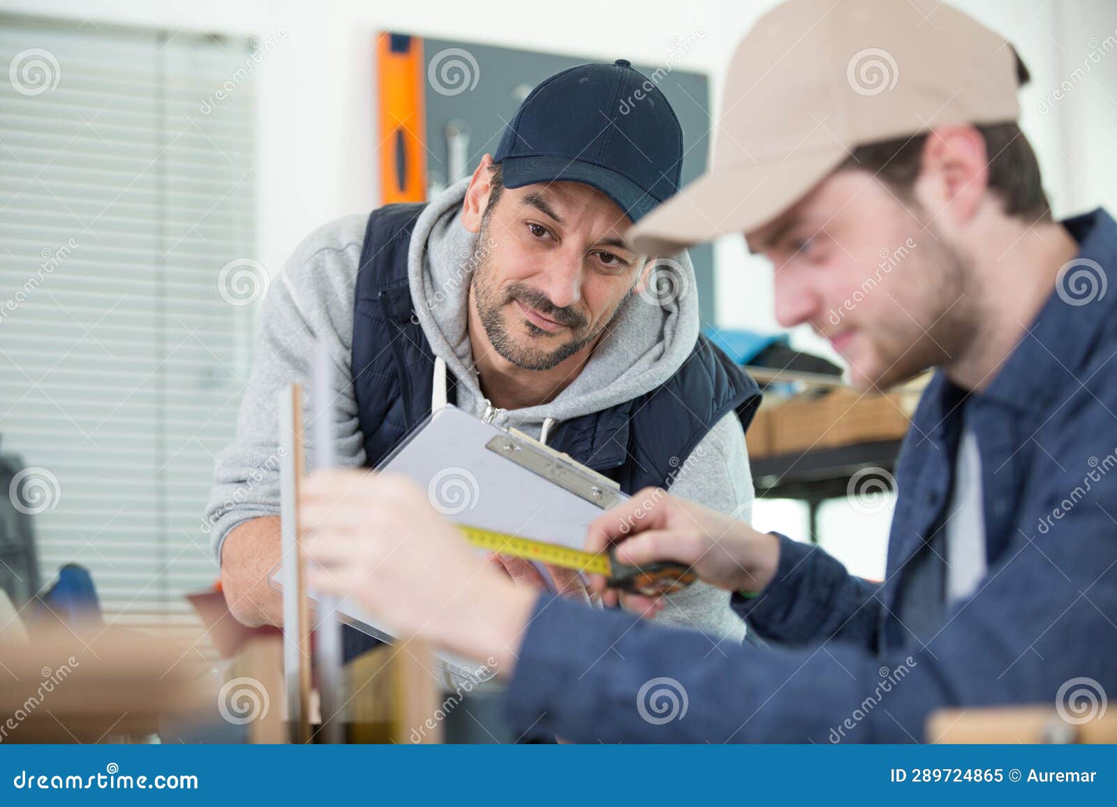 Man and apprentice at work stock image. Image of assembling - 289724865